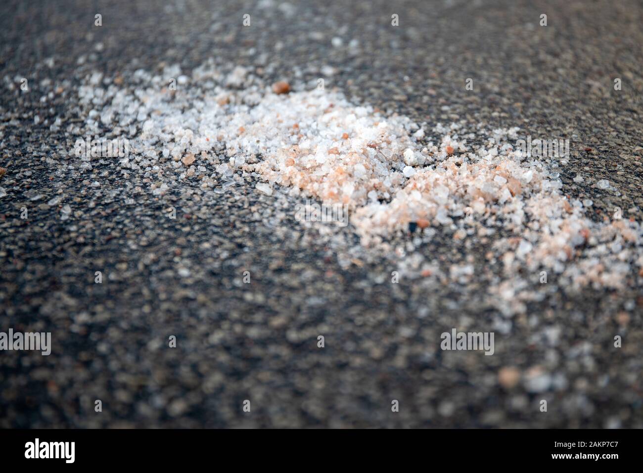 Salt spilled on the pavement. Winter season, slick and dangerous ...