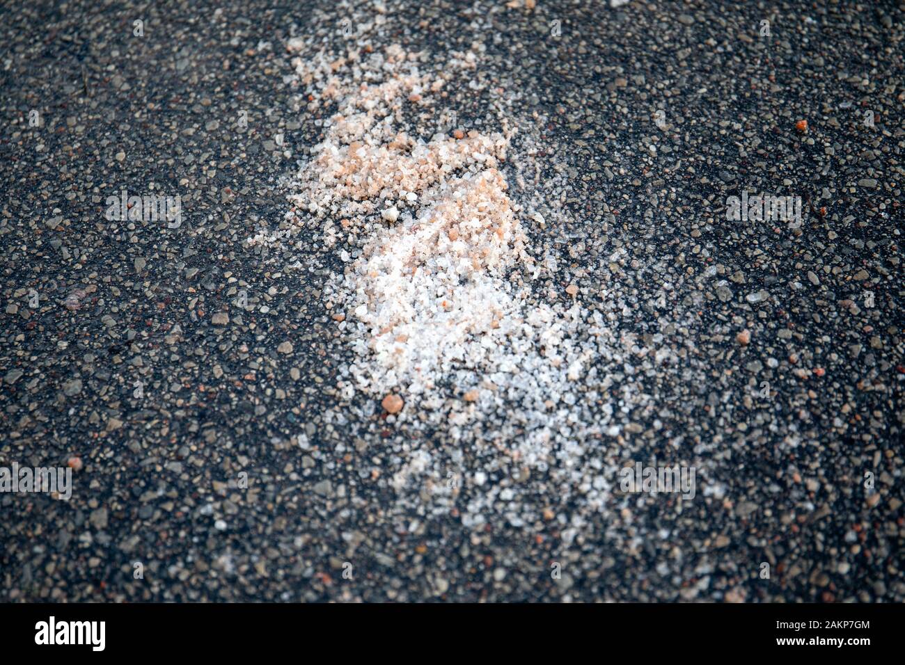 Salt spilled on the pavement. Winter season, slick and dangerous ...