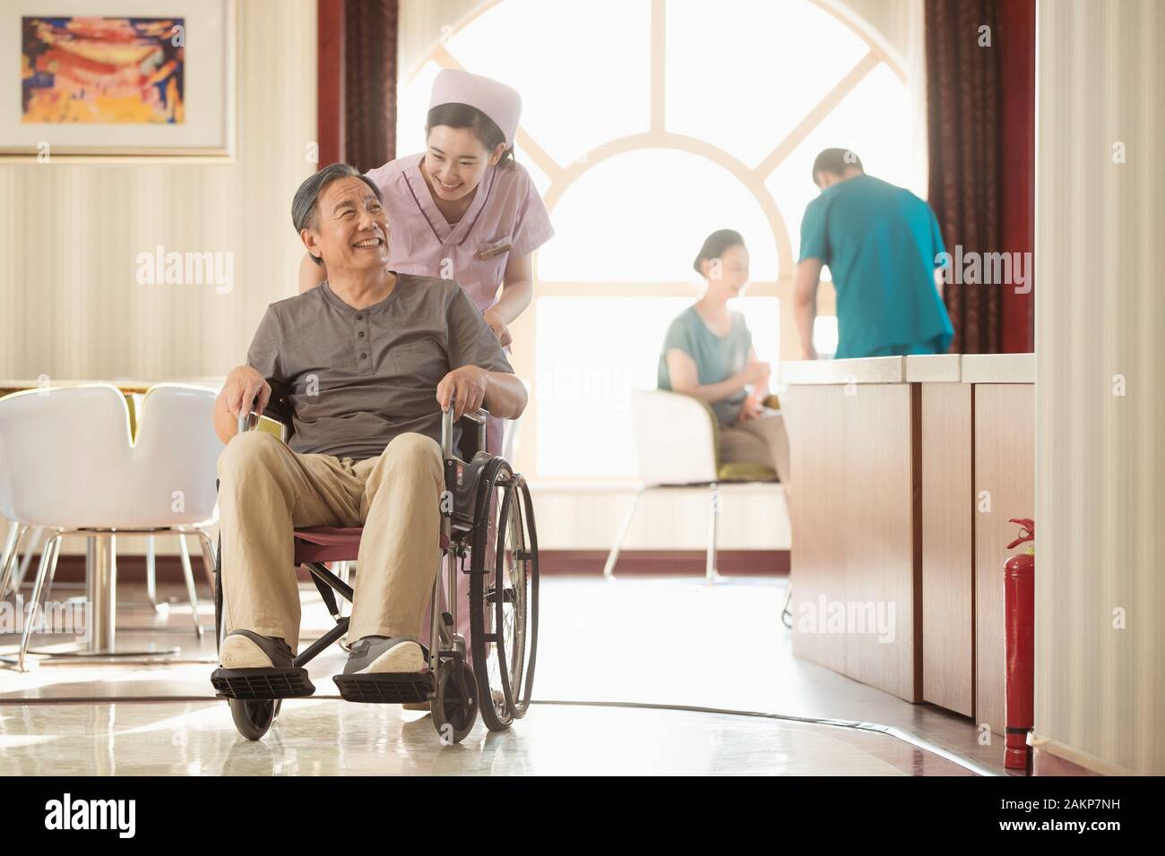The nurse pushing a wheelchair elderly people Stock Photo - Alamy