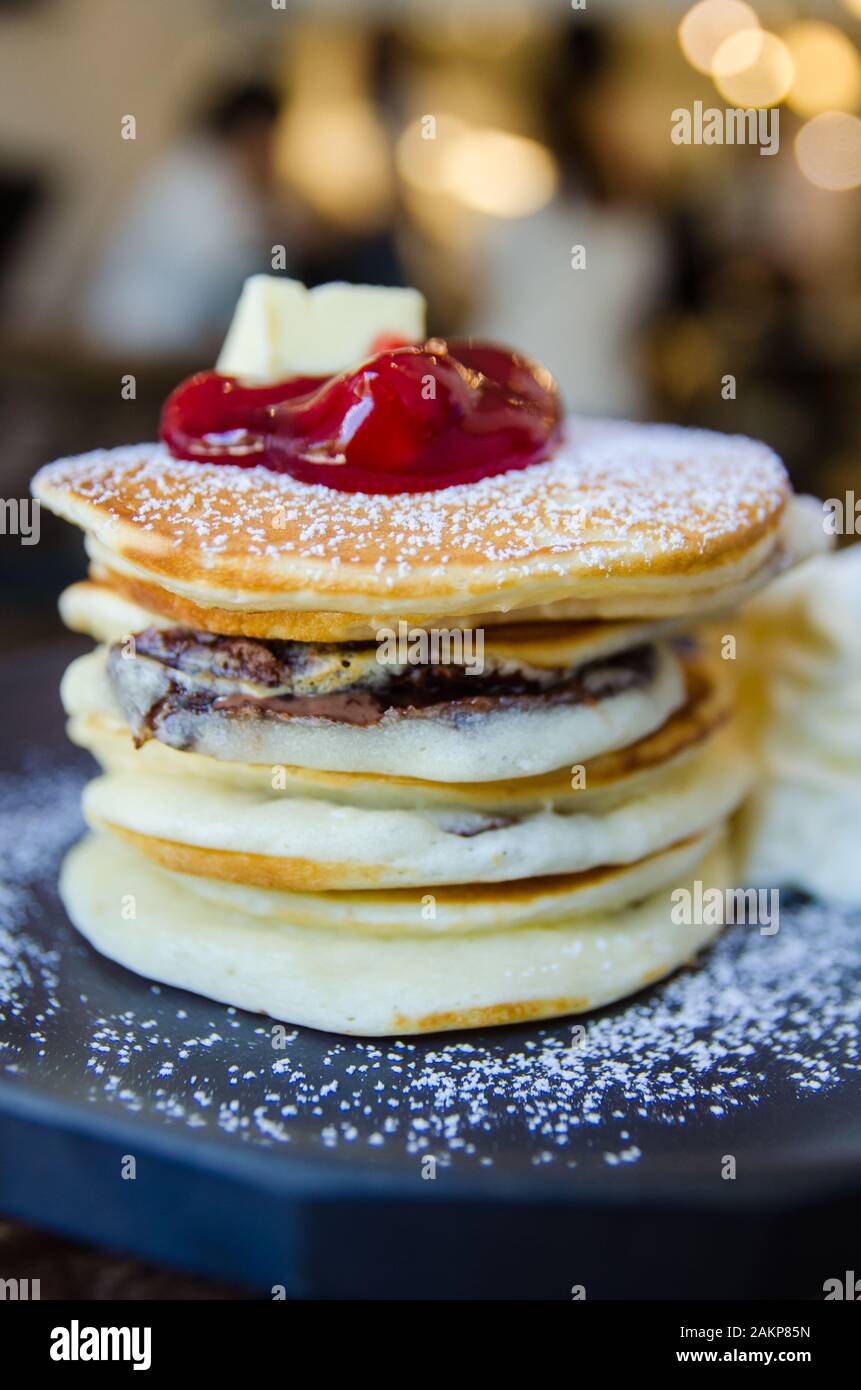 stack of pancake with strawberry on top on black plate Stock Photo - Alamy