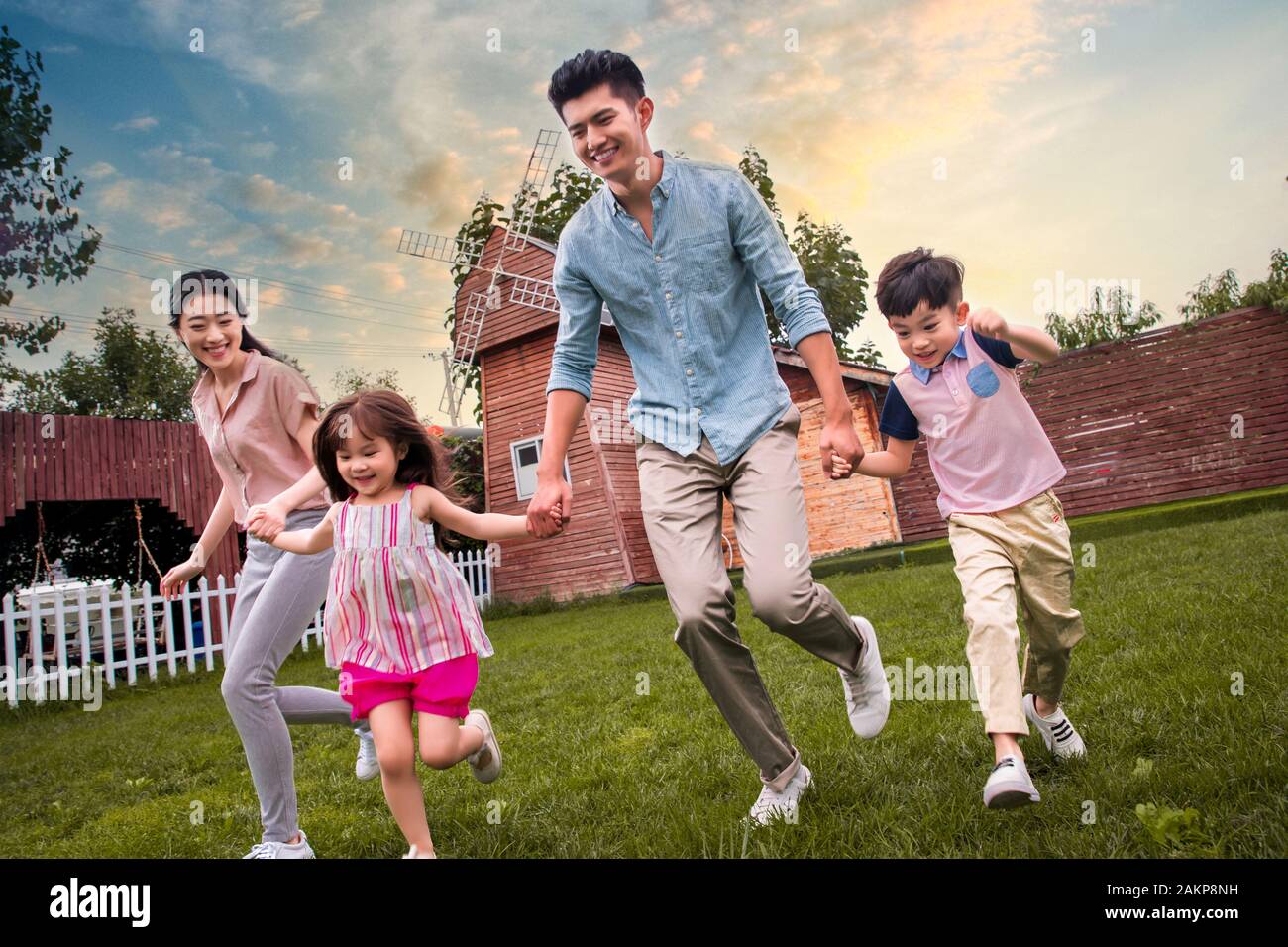 Happy family run on the grass Stock Photo - Alamy