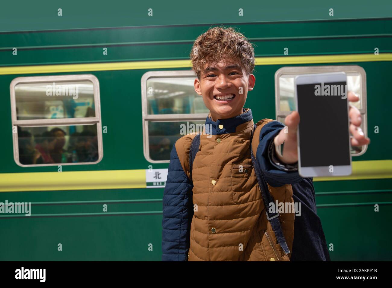 Young men show a mobile phone Stock Photo - Alamy