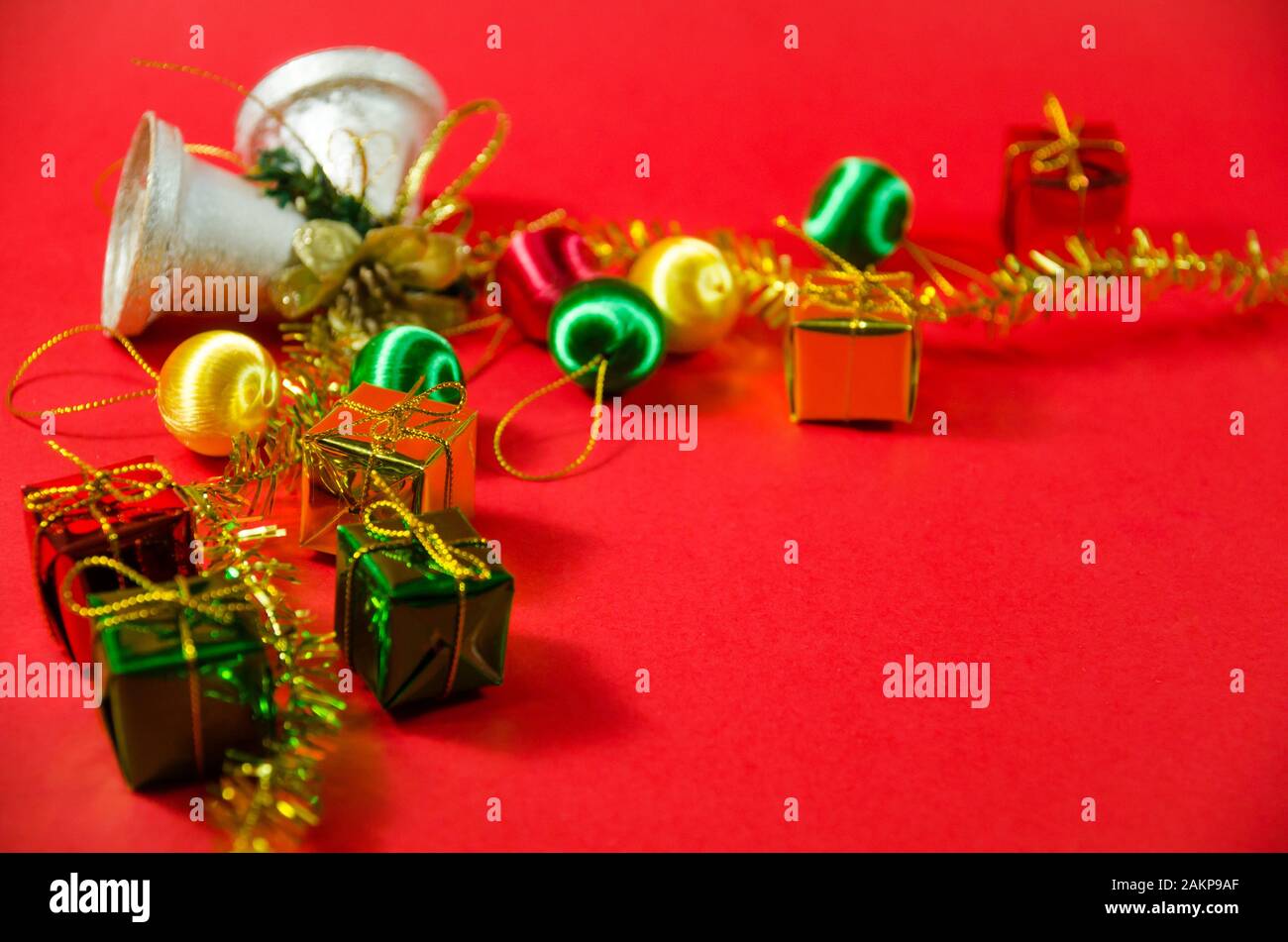 group of bell, ball and gift in christmas on red background on top view ...