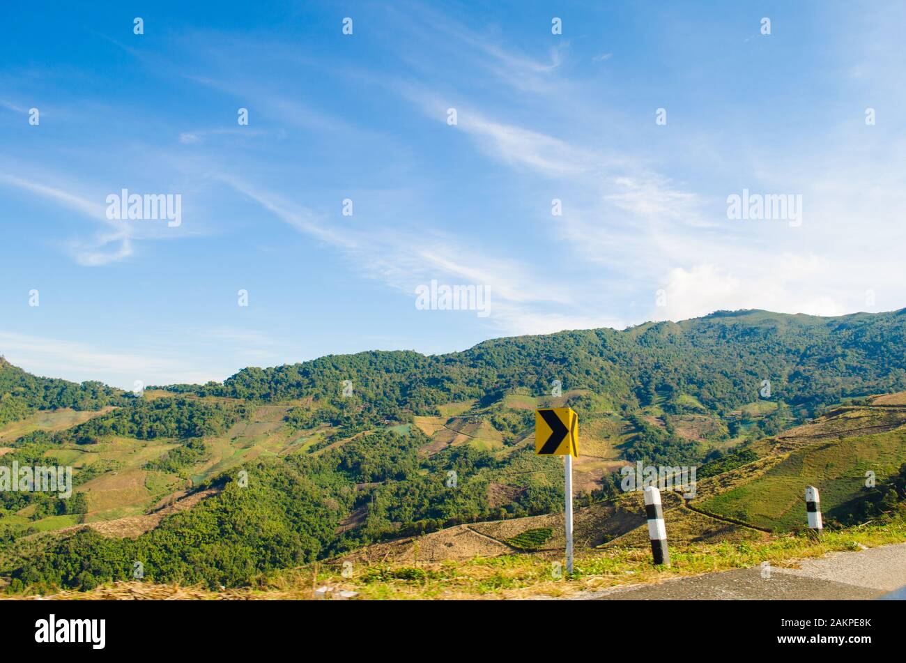yellow right curve sign on mountain Stock Photo - Alamy
