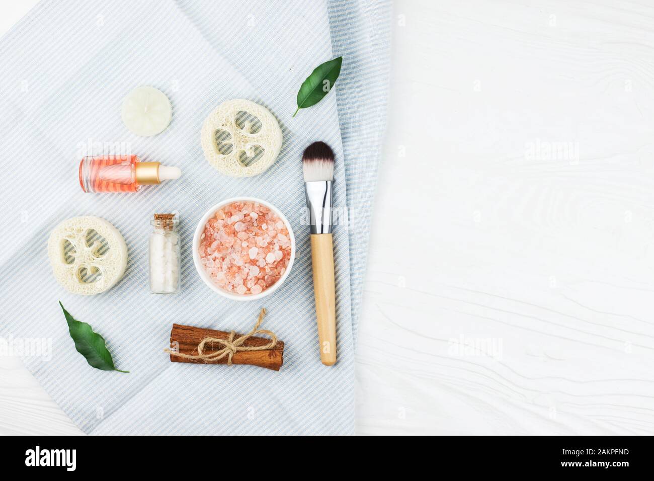 Homemade spa cosmetic set with salt and oil on white wooden background ...