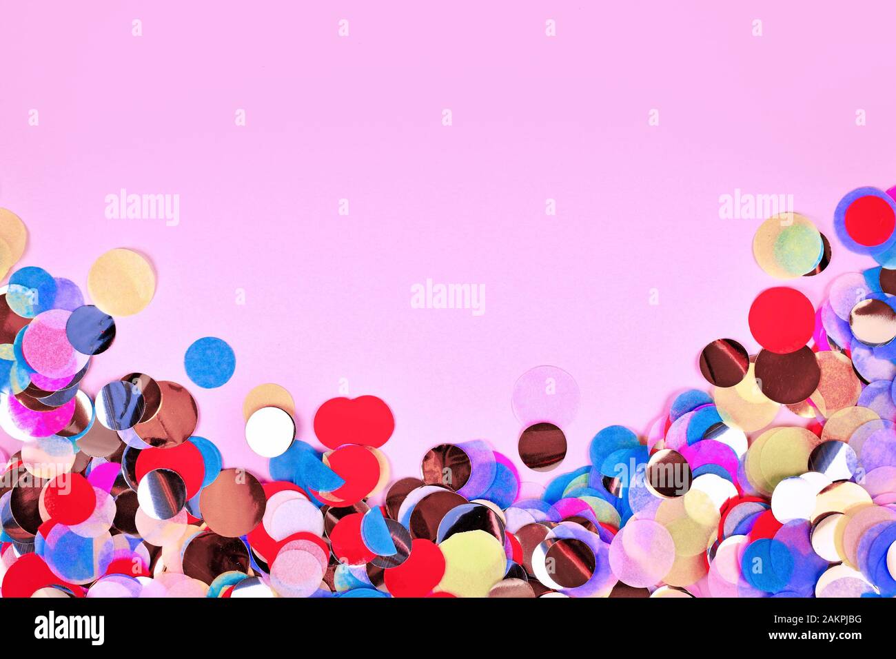Pink background with colorful paper confetti at bottom border and copy space above Stock Photo ...