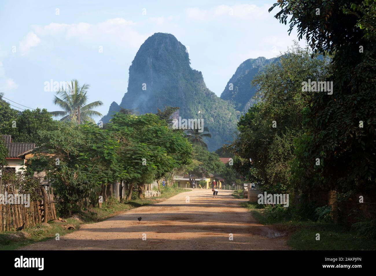 Road through village near Vang Vieng, Laos Stock Photo - Alamy