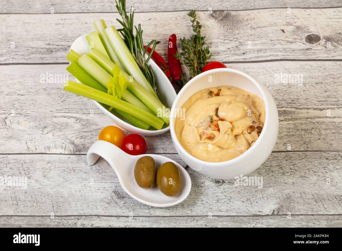 Vegan cuisine - Humus with celery sticks Stock Photo - Alamy