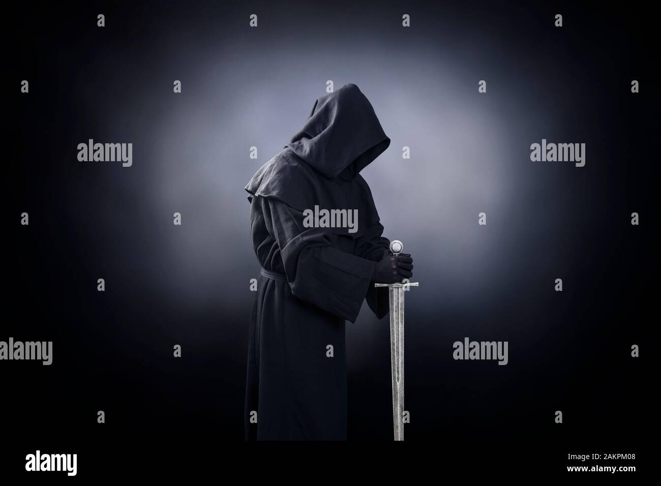Ghostly figure with medieval sword in the dark Stock Photo - Alamy