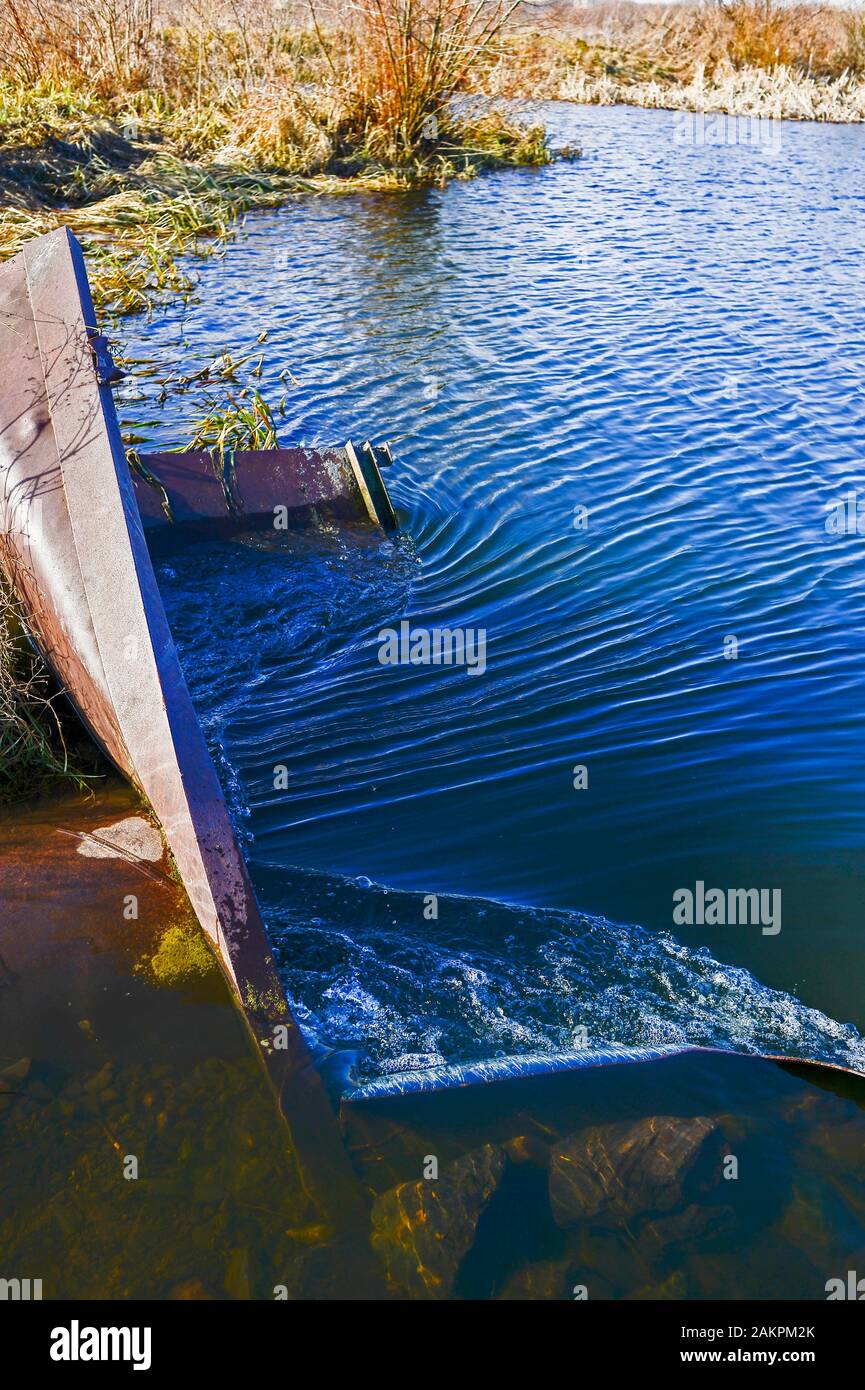 The rapid flow of water is directed to the pipe with the discharge of ...