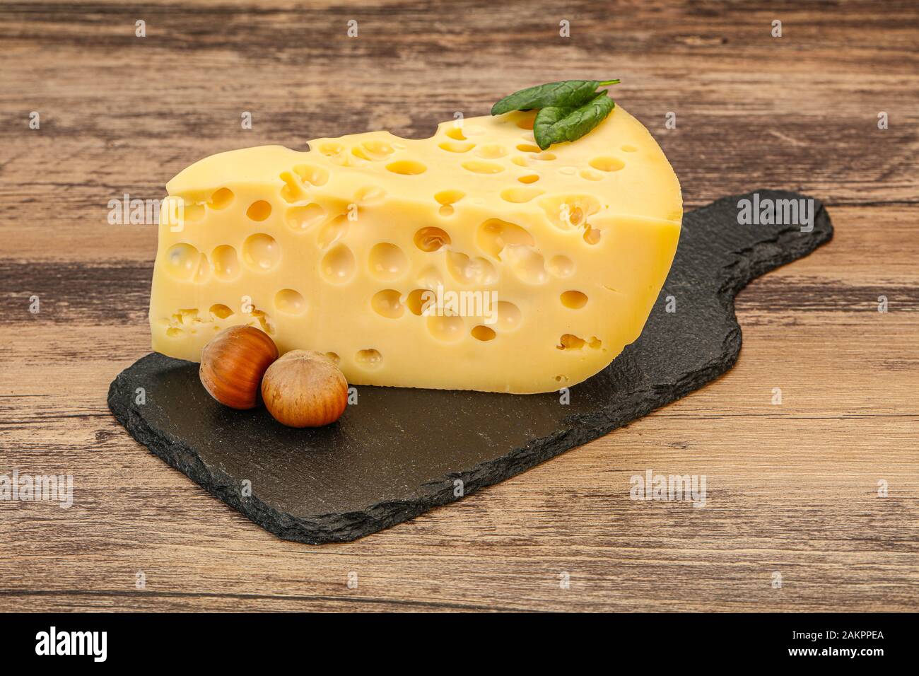 Maasdam cheese - dairy yellow triangle with holes Stock Photo - Alamy
