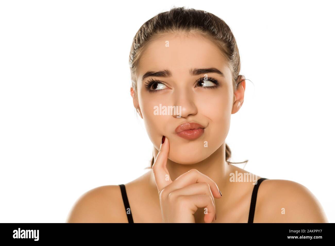 Young beautiful woman thinking on white background Stock Photo - Alamy