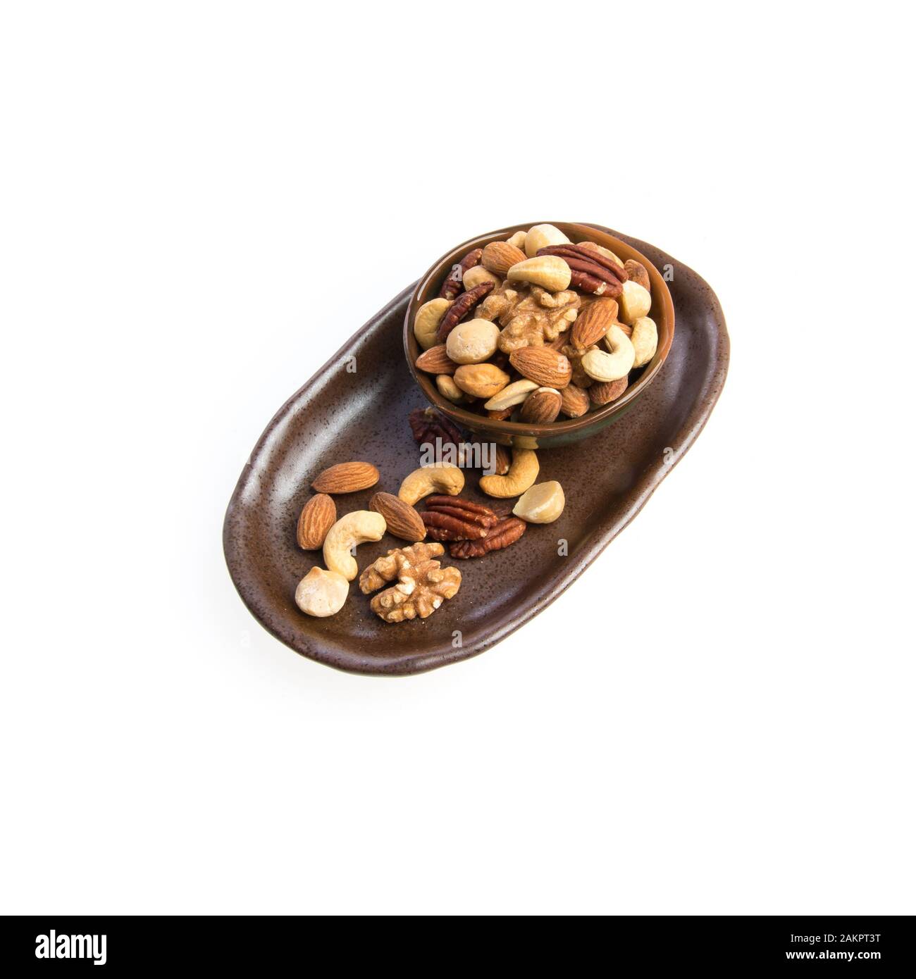 Assorted nuts on plate Cut Out Stock Images & Pictures - Alamy