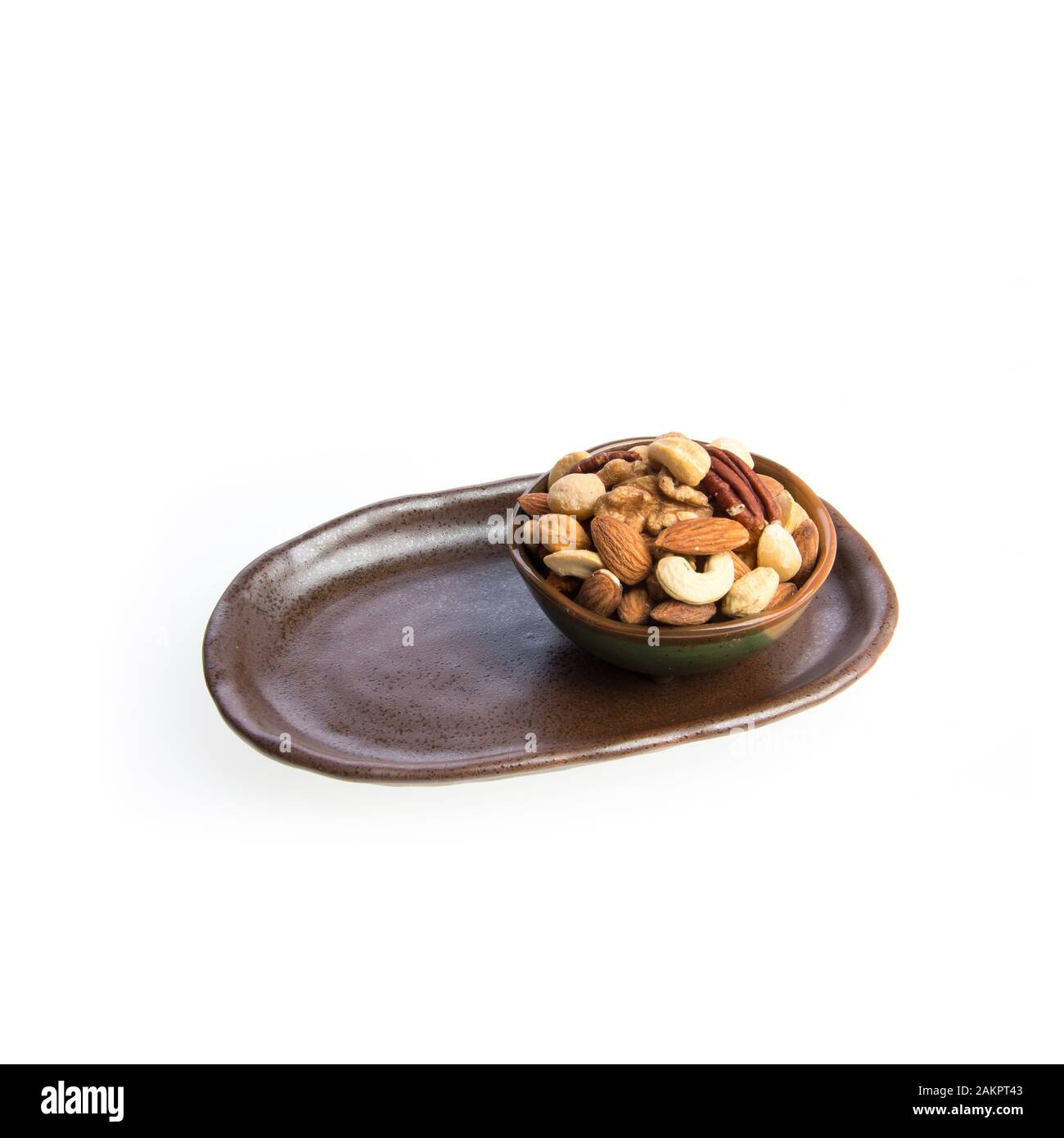 Assorted nuts on plate Cut Out Stock Images & Pictures - Alamy