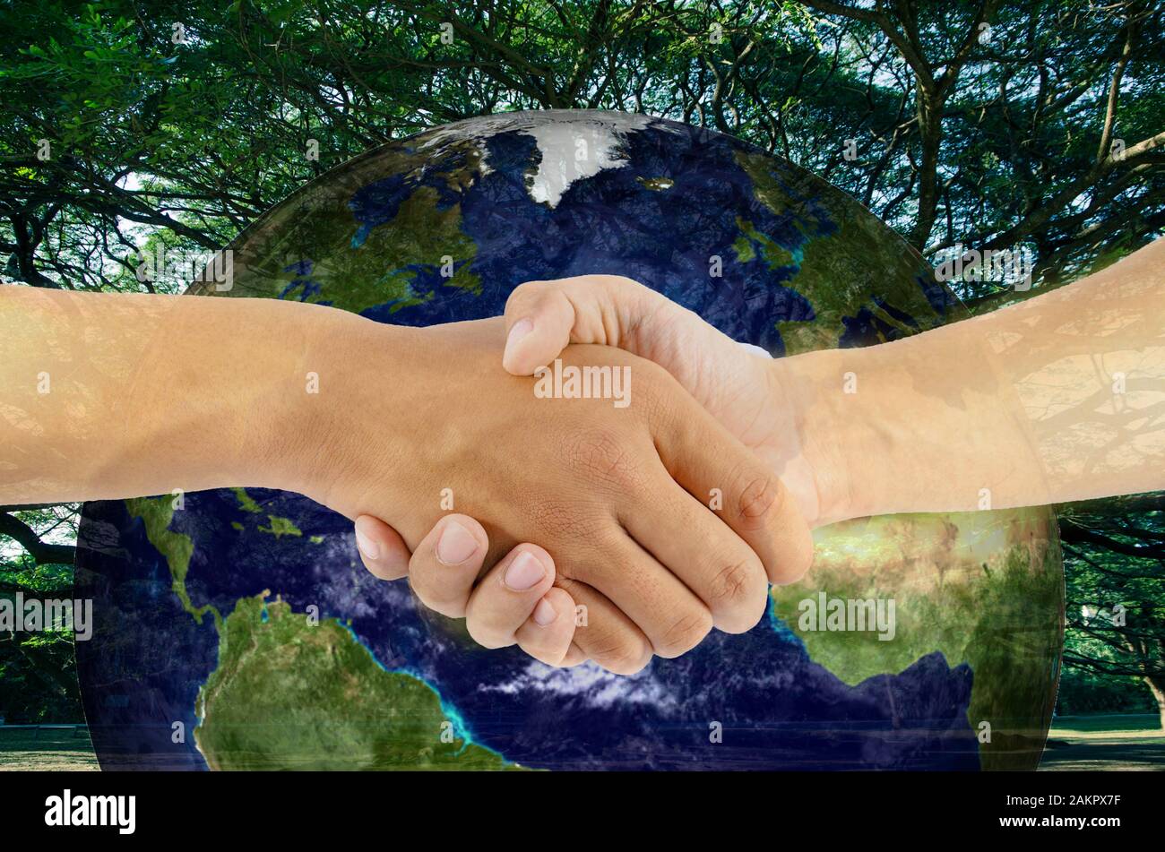 two man are hand shaking on earth and tree background, Elements of this ...