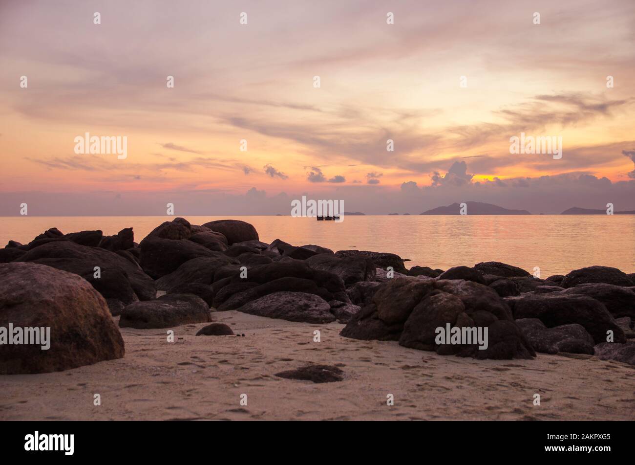 sunset beach with rock bay Stock Photo - Alamy
