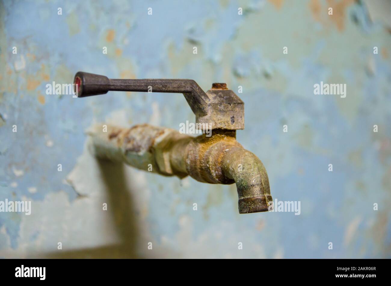 old rusty water tap on pale wall Stock Photo - Alamy