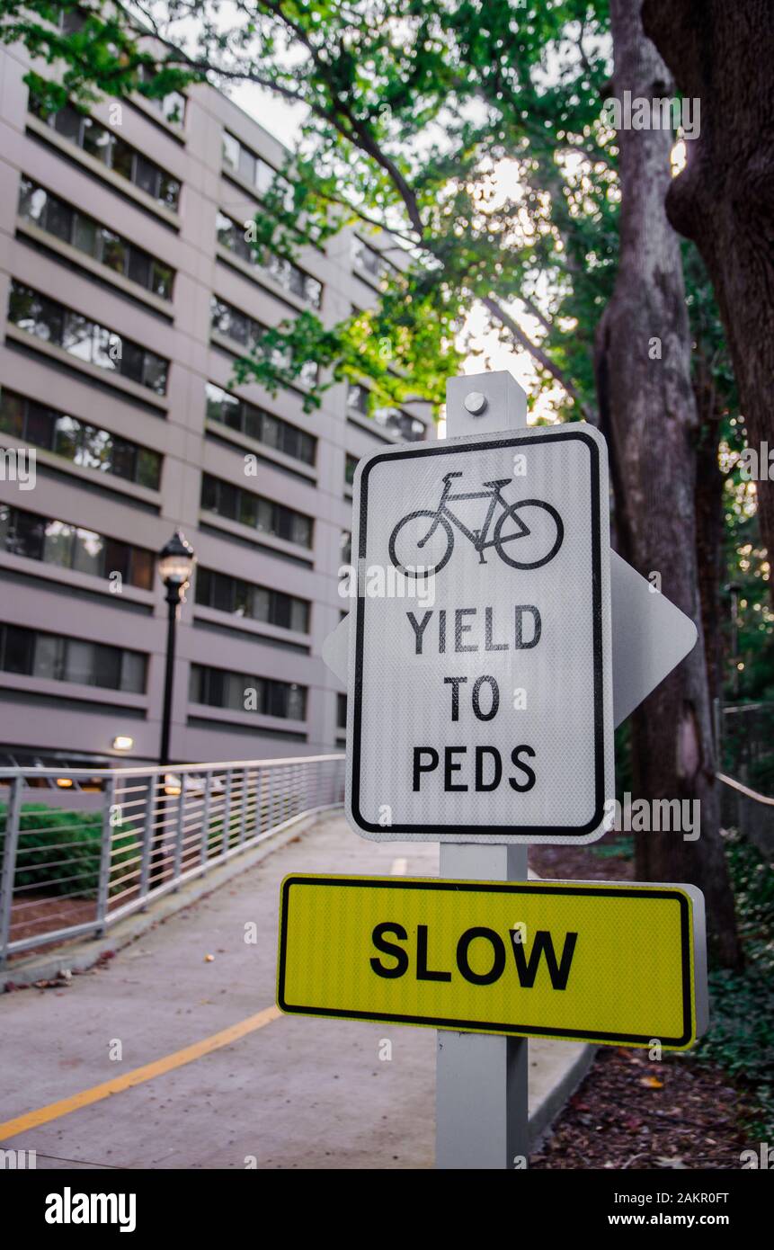 yield to peds sign with building background Stock Photo - Alamy