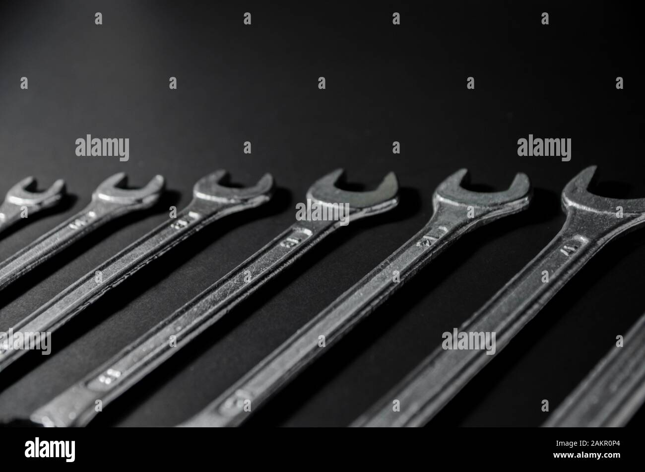 sort of silver wrench on black background in side view Stock Photo - Alamy