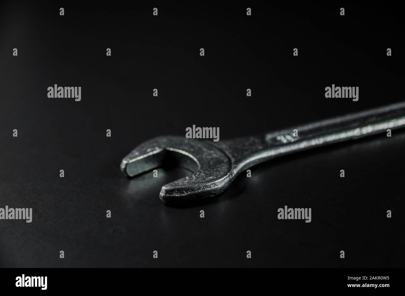 side view of silver wrench on dark light Stock Photo - Alamy