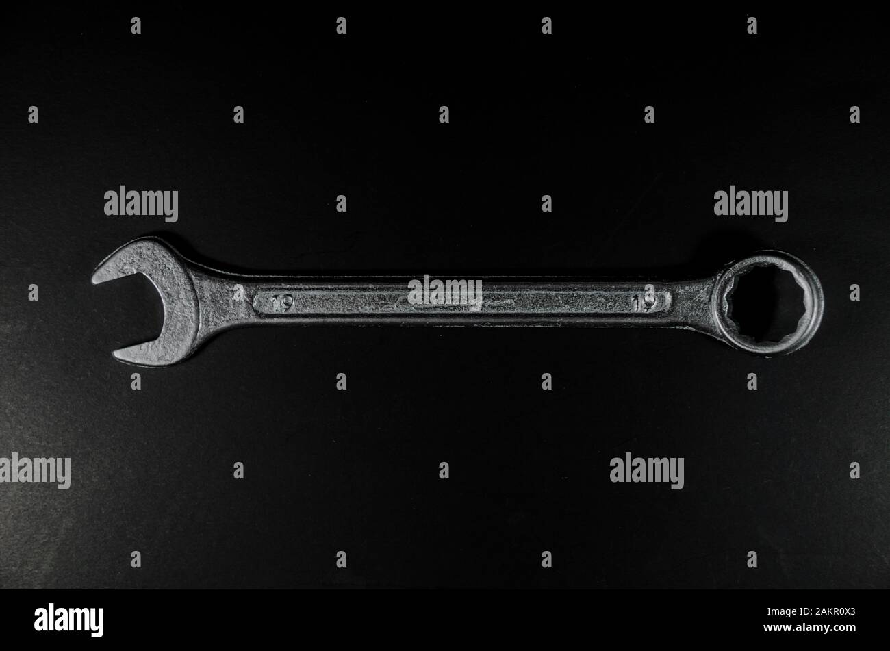 top view of a silver wrench on black background Stock Photo - Alamy