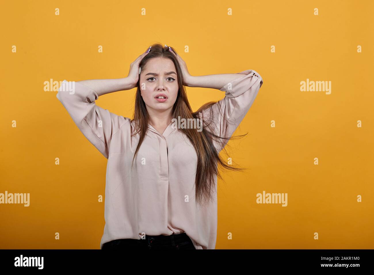 Confused woman keeping hands on head, having headache, disappointed ...