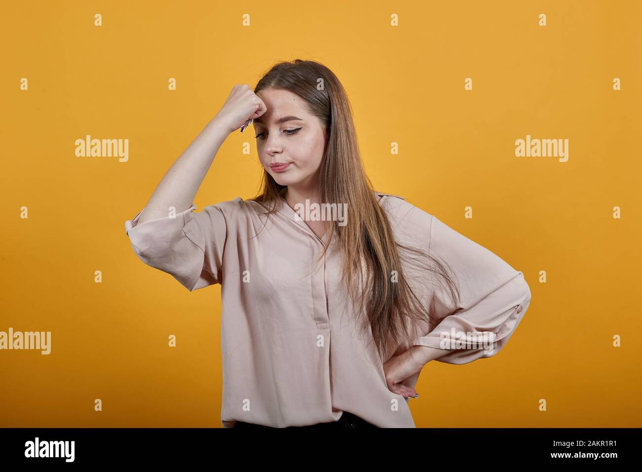 Strong woman keeping fins on forehead, headache, holding hand on belt ...