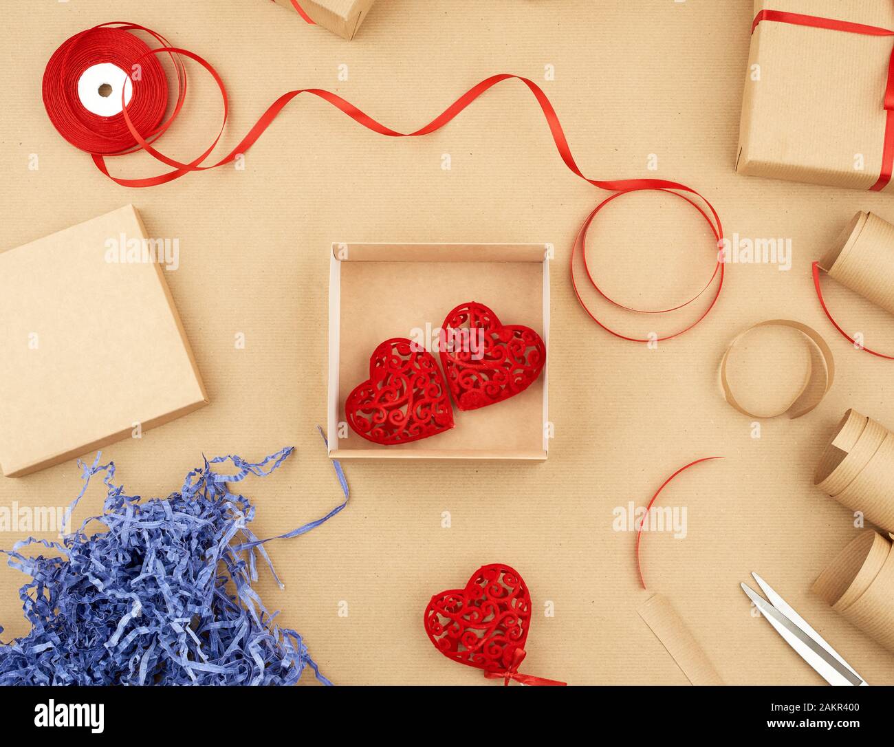 brown kraft paper, packed gift boxes and tied with a red ribbon, red ...