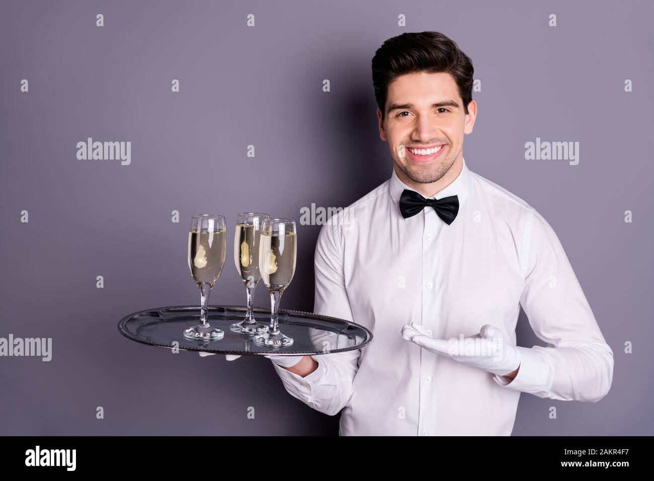 Here your order. Positive cheerful waiter bring client guest alcohol ...