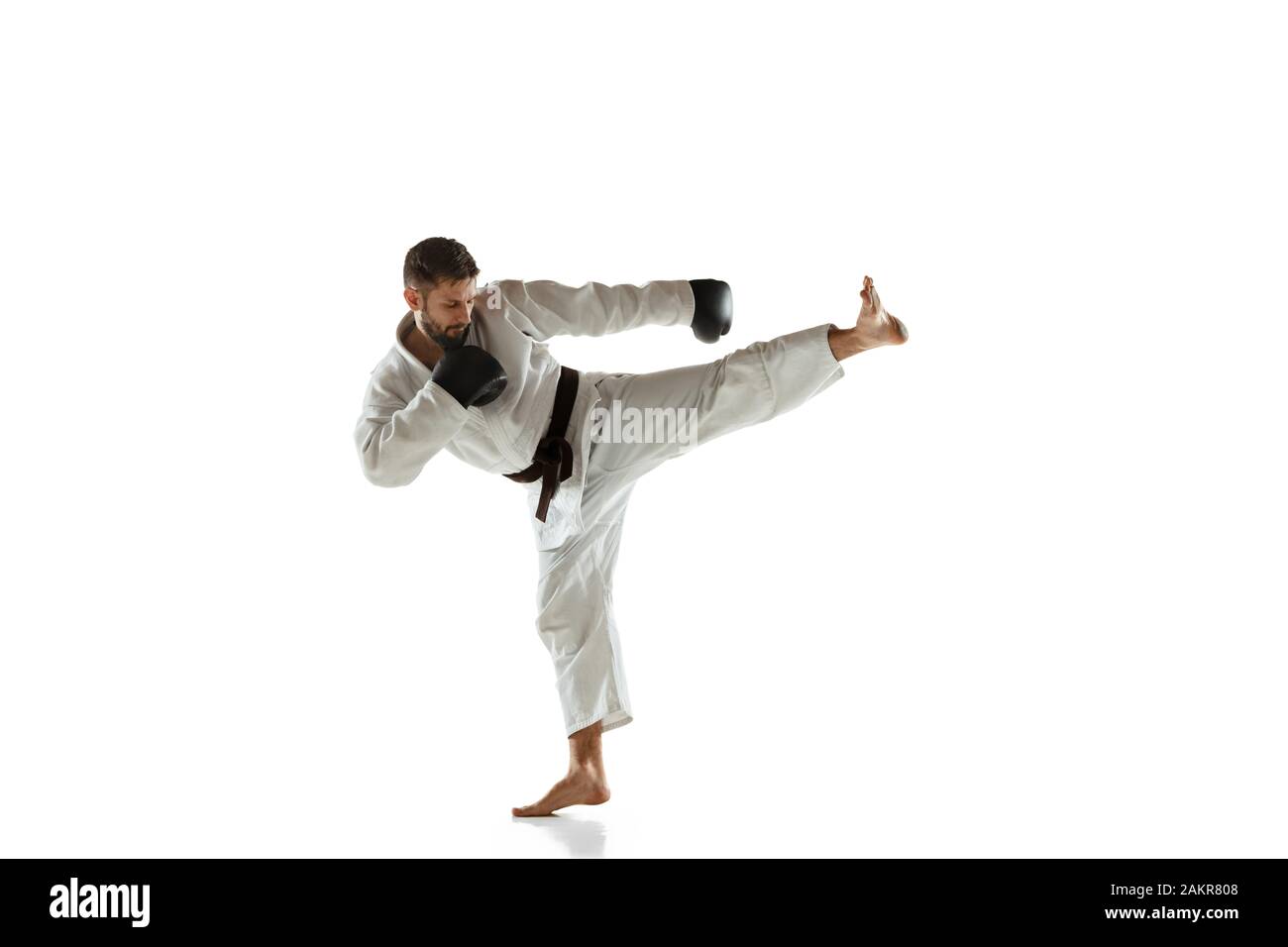 Confident coach in kimono practicing hand-to-hand combat, martial arts ...