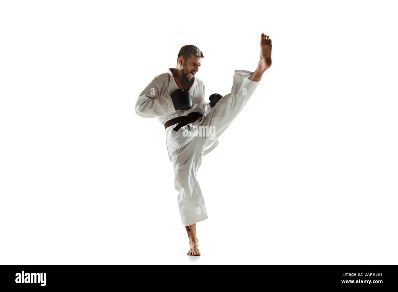 Confident coach in kimono practicing hand-to-hand combat, martial arts ...