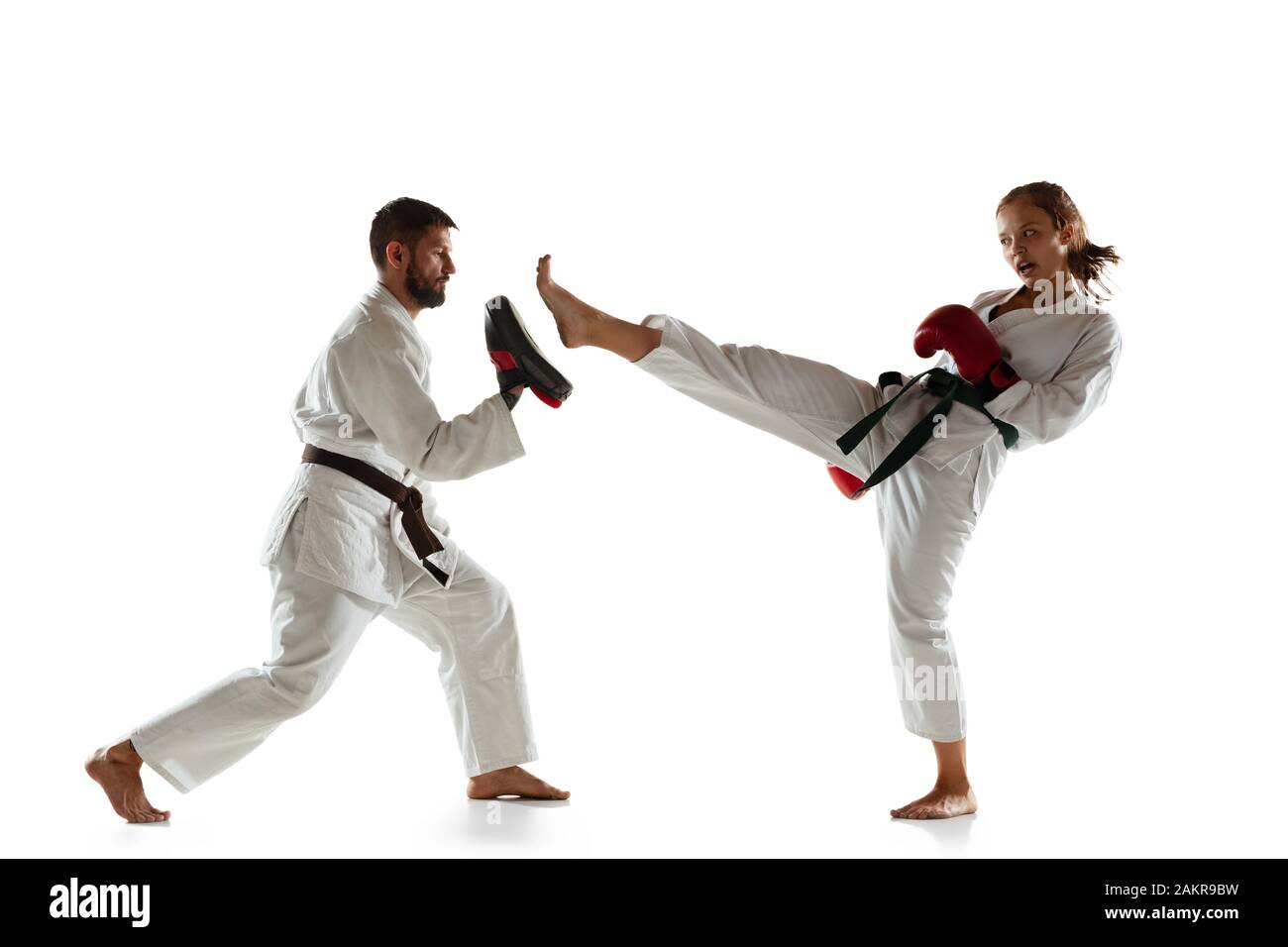 Junior in kimono practicing hand-to-hand combat with coach, martial ...