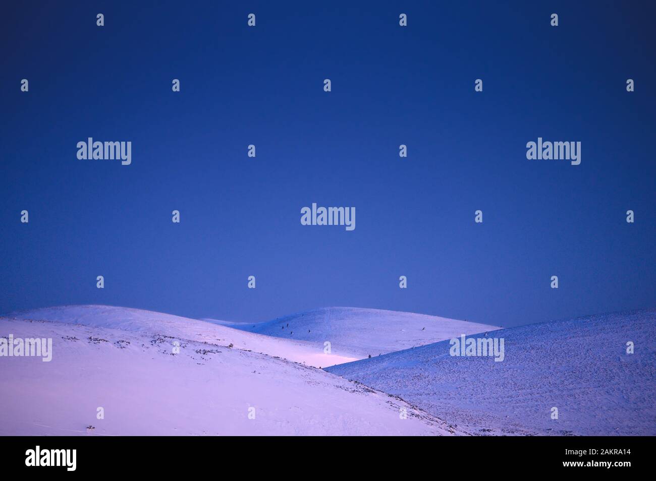 Blue wallpaper with edit space. Hills covered by snow over blue sky ...