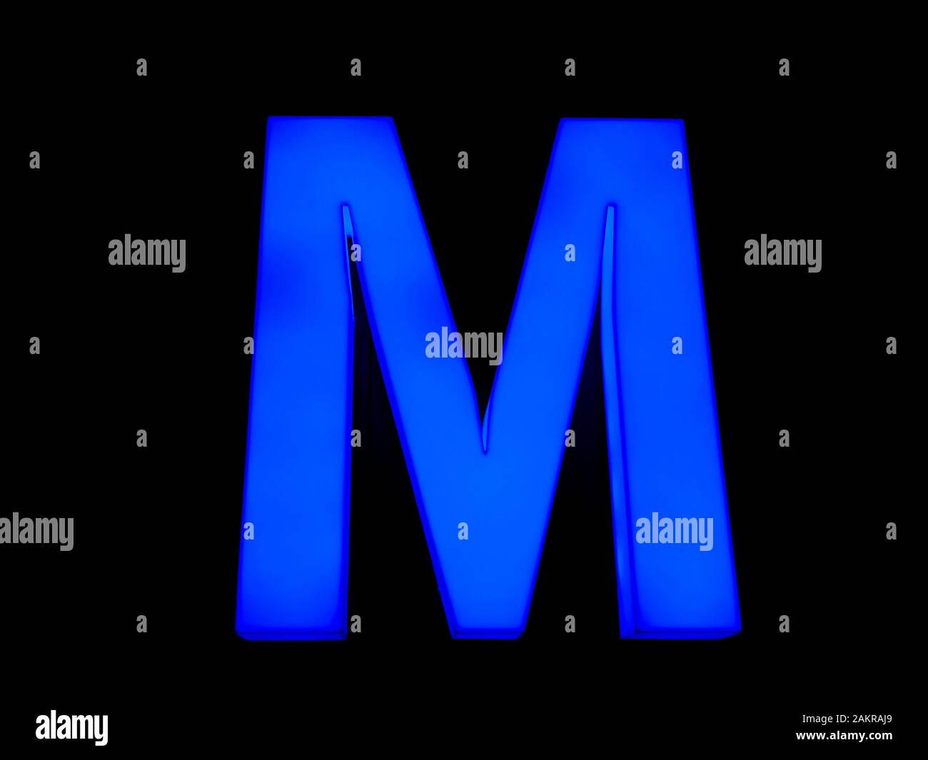 Blue neon light capital letter M over black background Stock Photo - Alamy