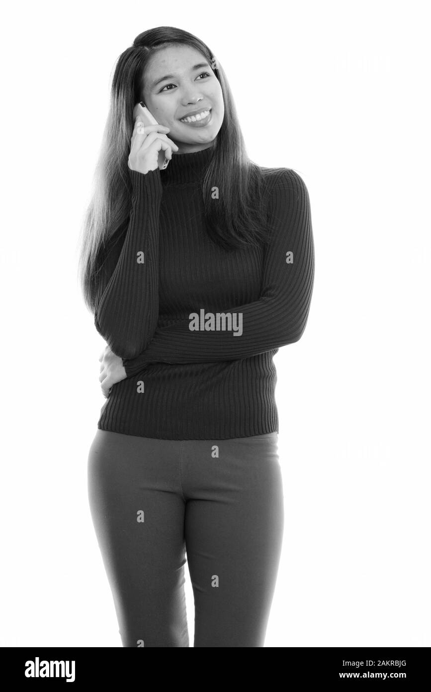 Young asian woman smile while talking on smartphone hi-res stock ...