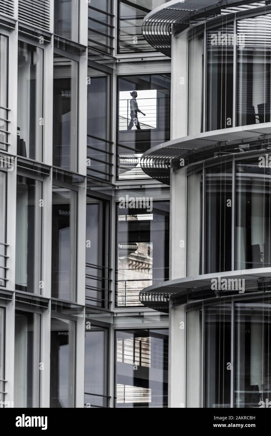Modern architecture with glass windows, man walking in a corridor, Paul ...