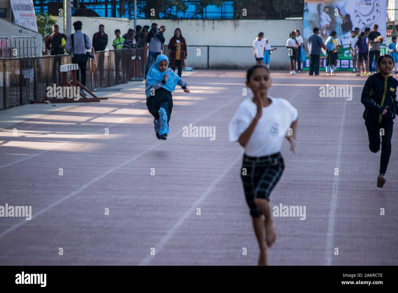 Girls running in 100 meter race compition Stock Photo - Alamy