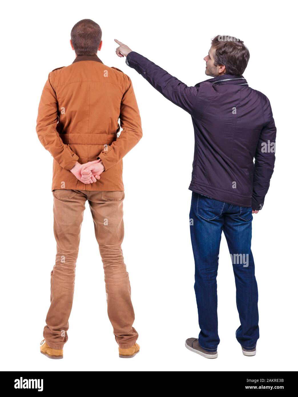 Back view of couple couple in winter jackets pointing. beautiful ...