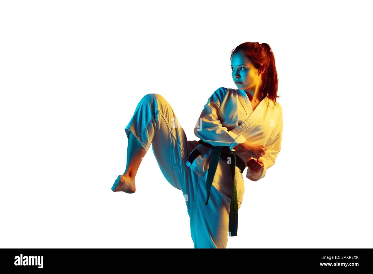 Step. Confident junior in kimono practicing hand-to-hand combat ...