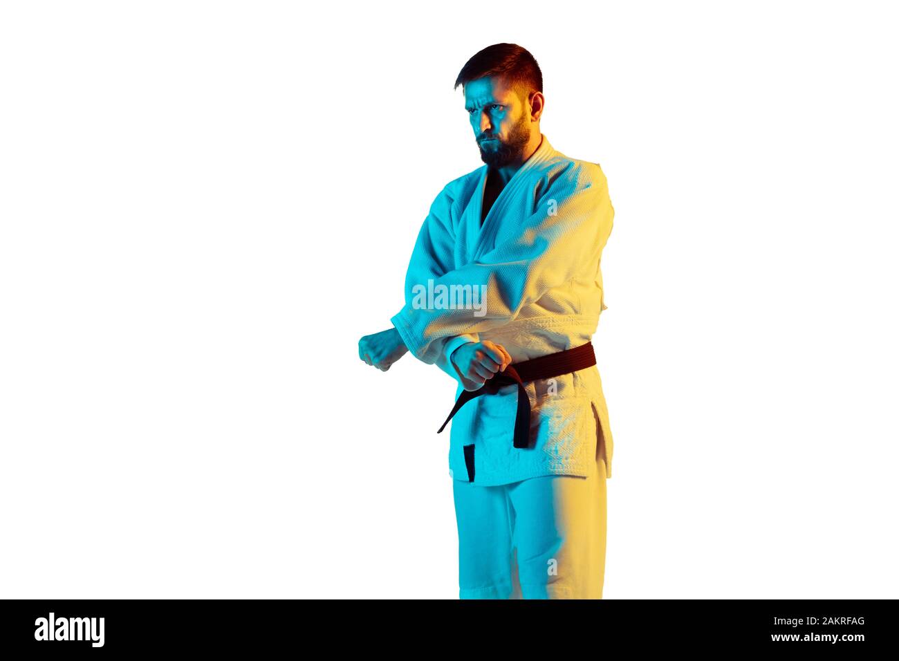 Angry. Confident coach in kimono practicing hand-to-hand combat ...