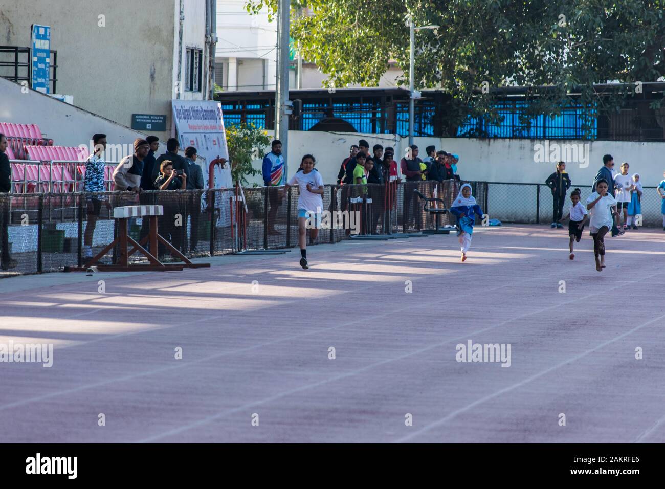 Girls running in 100 meter race compition Stock Photo - Alamy