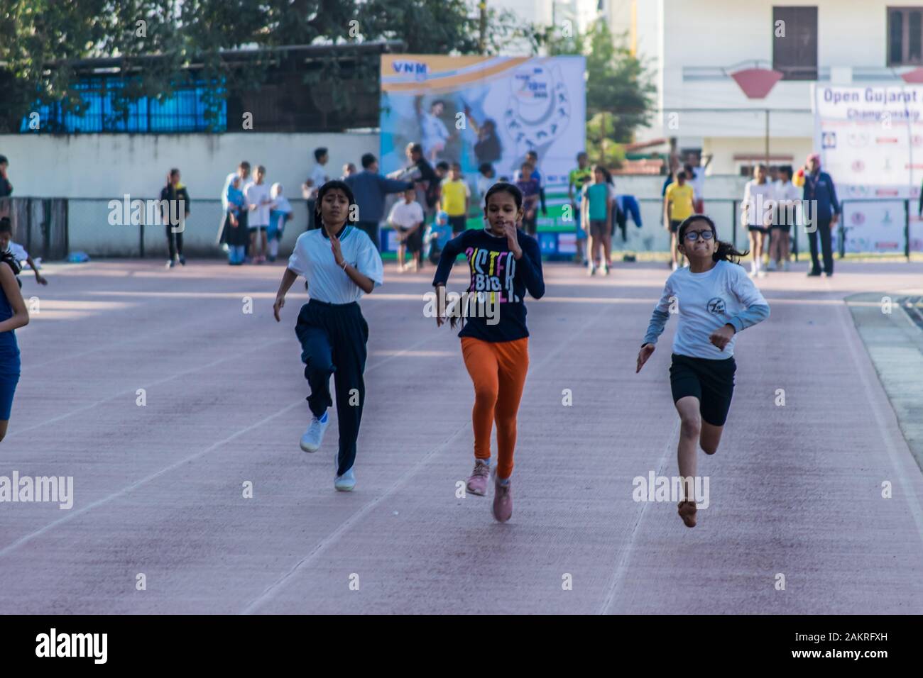 Girls running in 100 meter race compition Stock Photo - Alamy