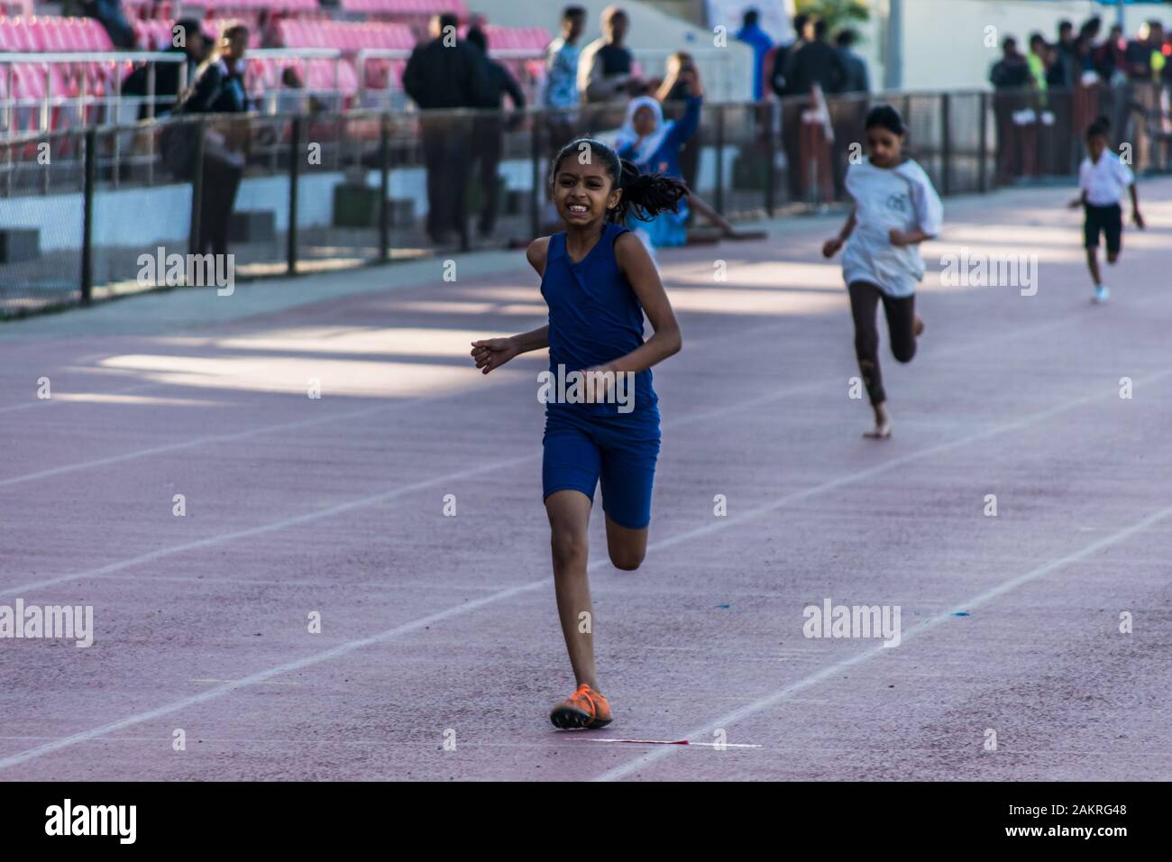 Girls running in 100 meter race compition Stock Photo - Alamy