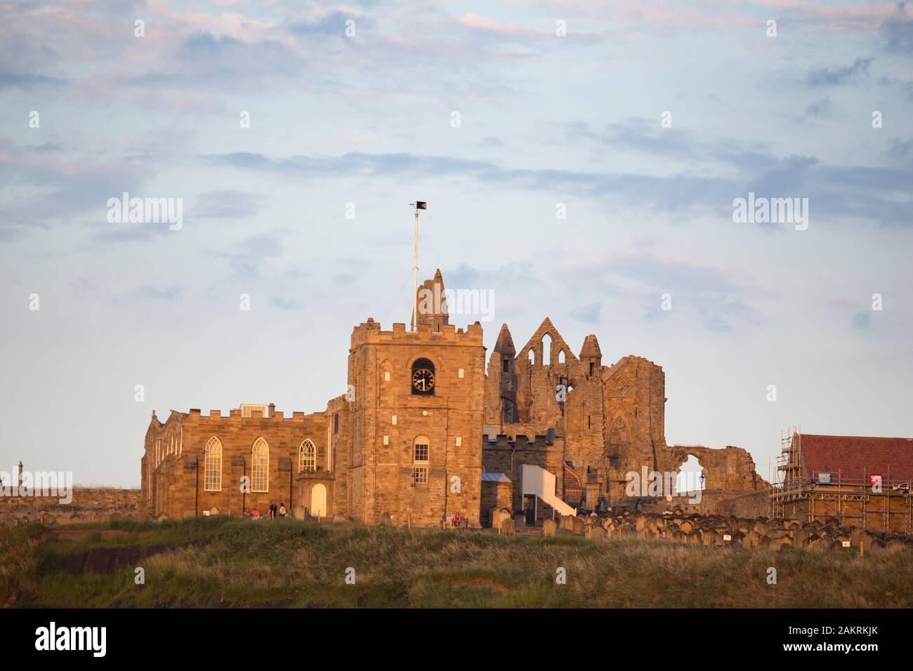 Whitby, the Church of St Mary with the Abbey ruins behind Stock Photo ...