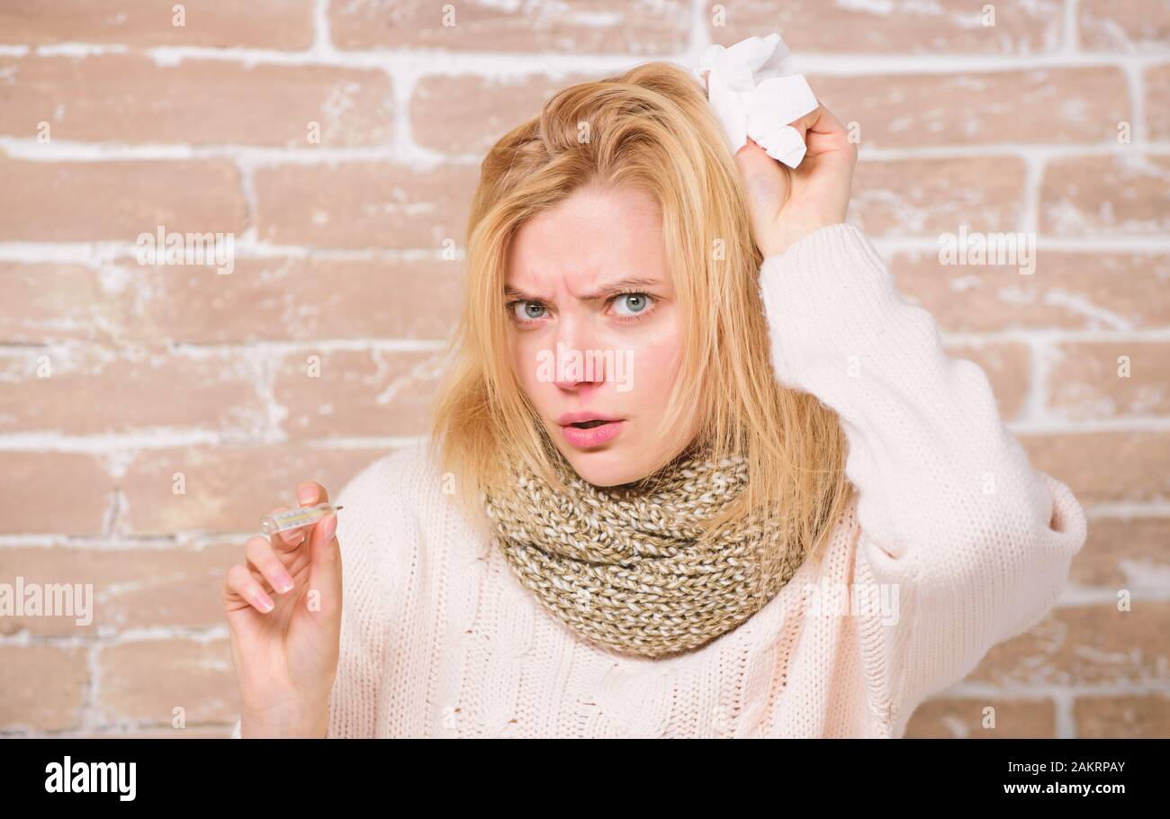 Being febrile. Sick woman holding fever thermometer. Becoming unwell ...