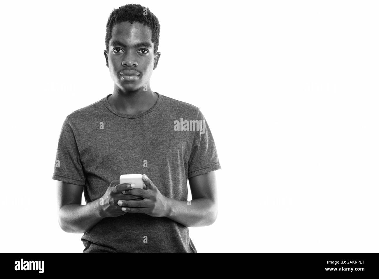 Black teen boy looking at phone Black and White Stock Photos & Images ...