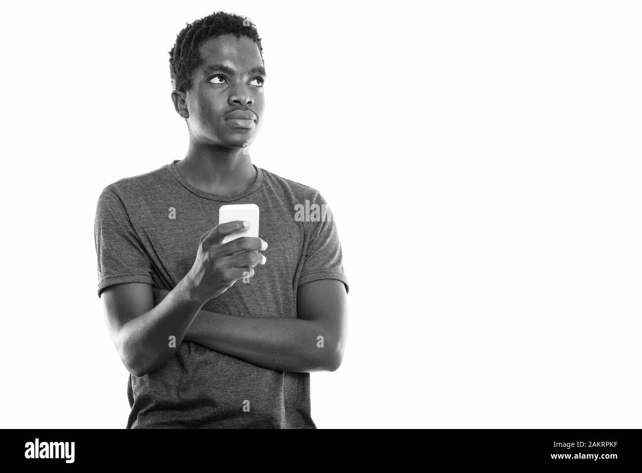 Black teen boy looking at phone Black and White Stock Photos & Images ...