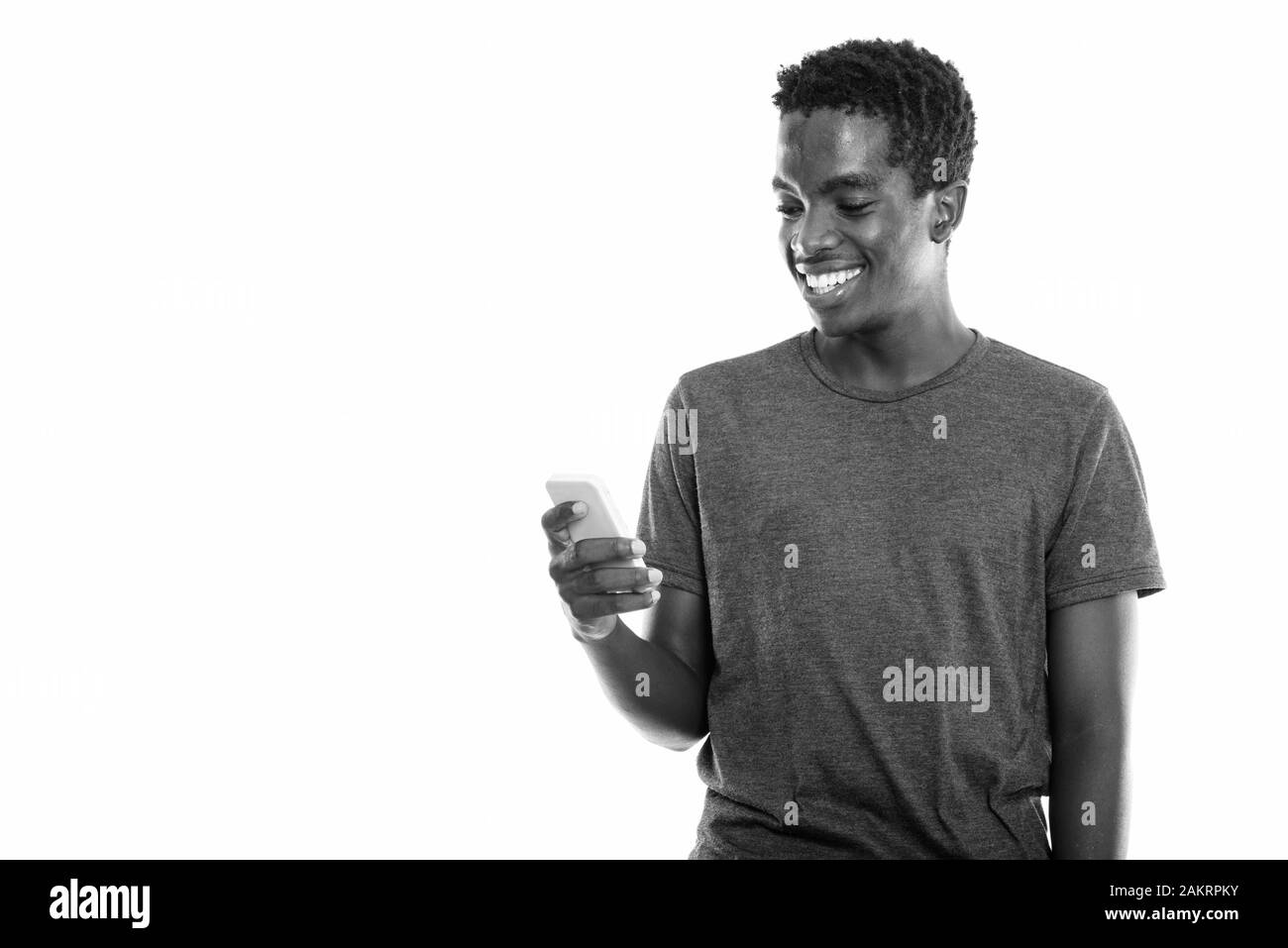 Black teen boy looking at phone Black and White Stock Photos & Images ...
