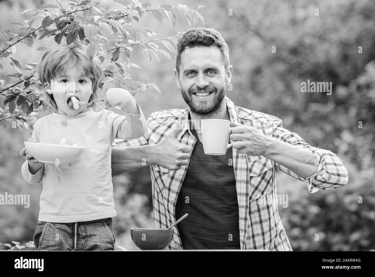 Father son eat food and have fun. Little boy and dad eating. Nutrition ...