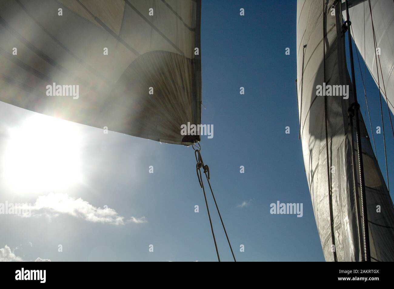 Sailing yacht rigging seen with sun backlight against a blue sky Stock ...